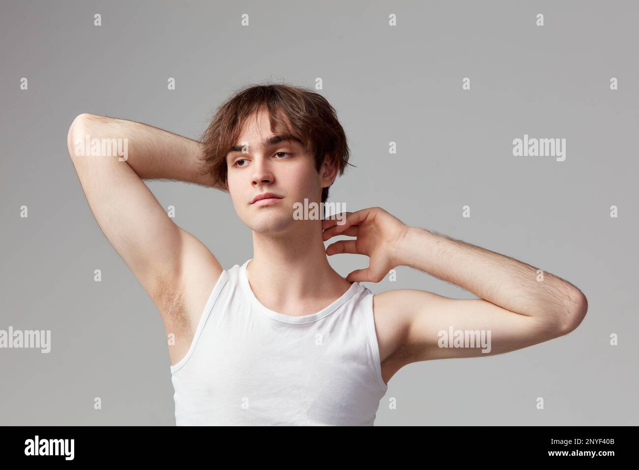 Studio portrait of young man with well-kept skin posing in singlet ...