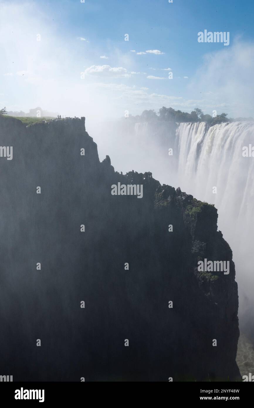 Victoria Falls seen from Zambia side. Tourist stand on the edge above ...