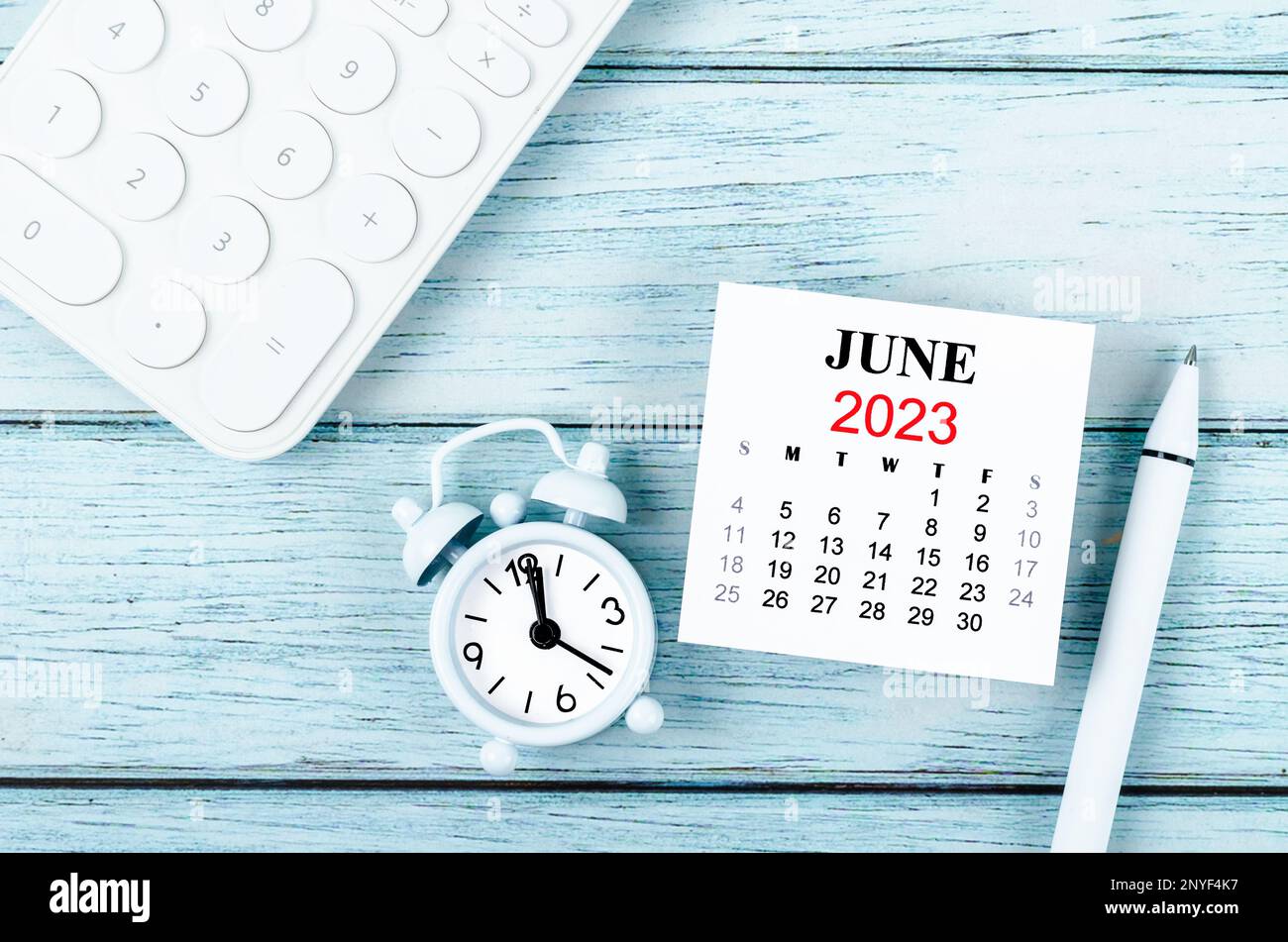 The June 2023 Monthly calendar year and alarm clock with calculator on ...