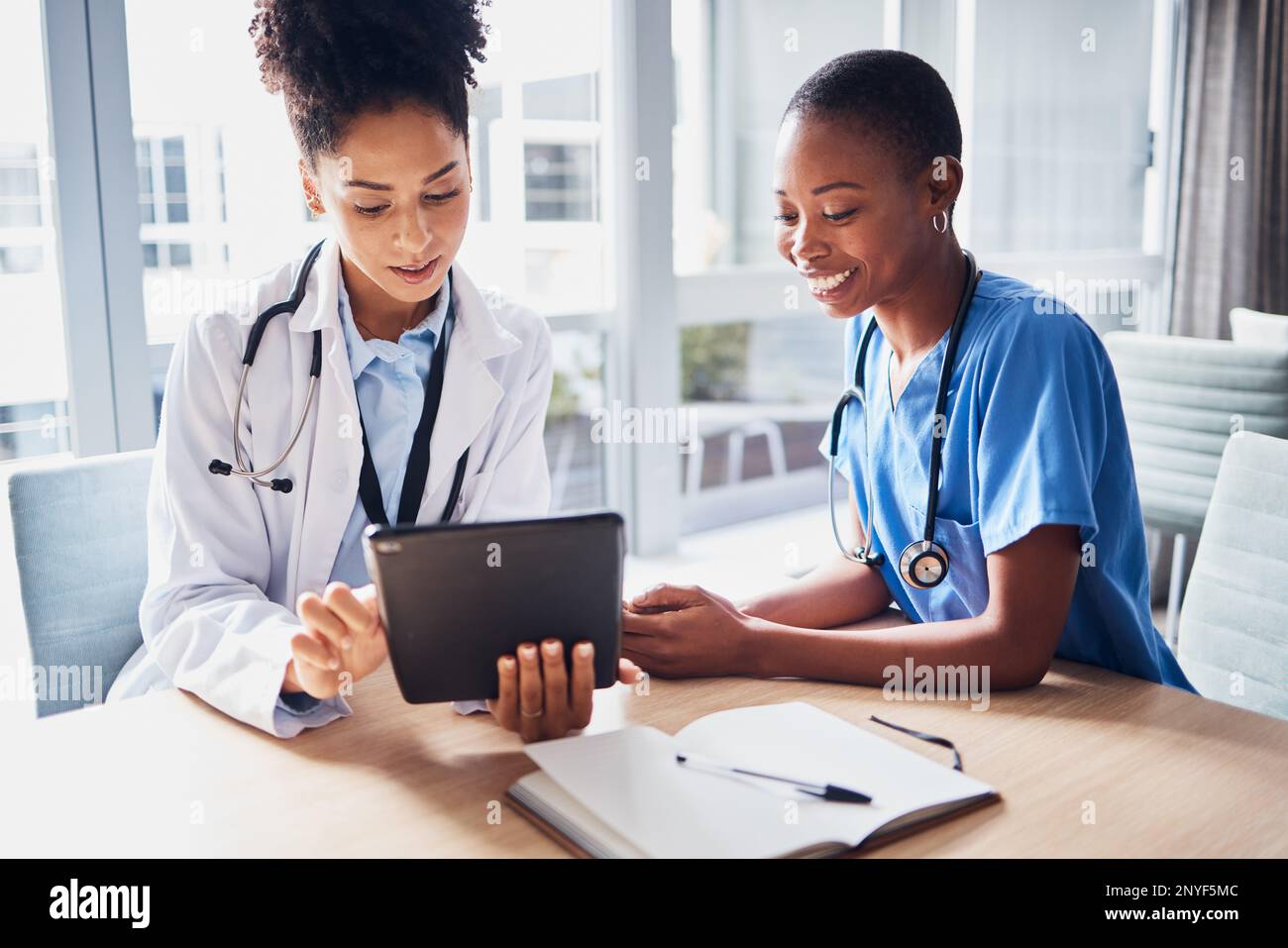 Tablet, black woman or doctors with medical research reading news or ...