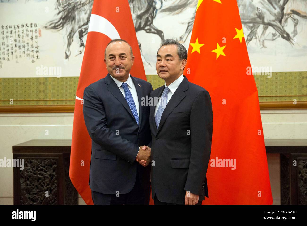 Chinese Foreign Minister Wang Yi (R) shakes hands with Turkish Foreign ...