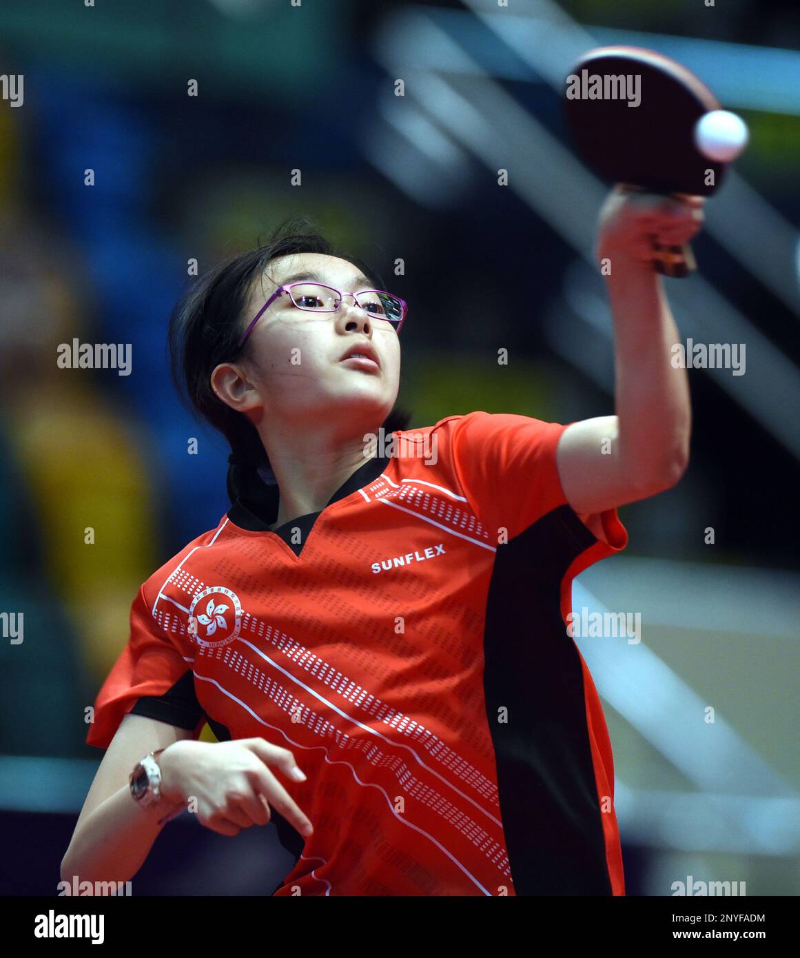 Ng Wing Lam of Hong Kong returns a shot as she and Lee Ka Yee compete ...
