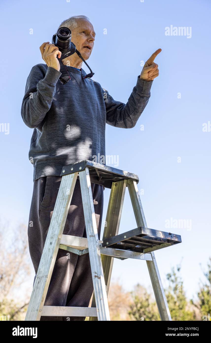 Jim Krogle, a professional artist, guides a car with the Fallbrook ...