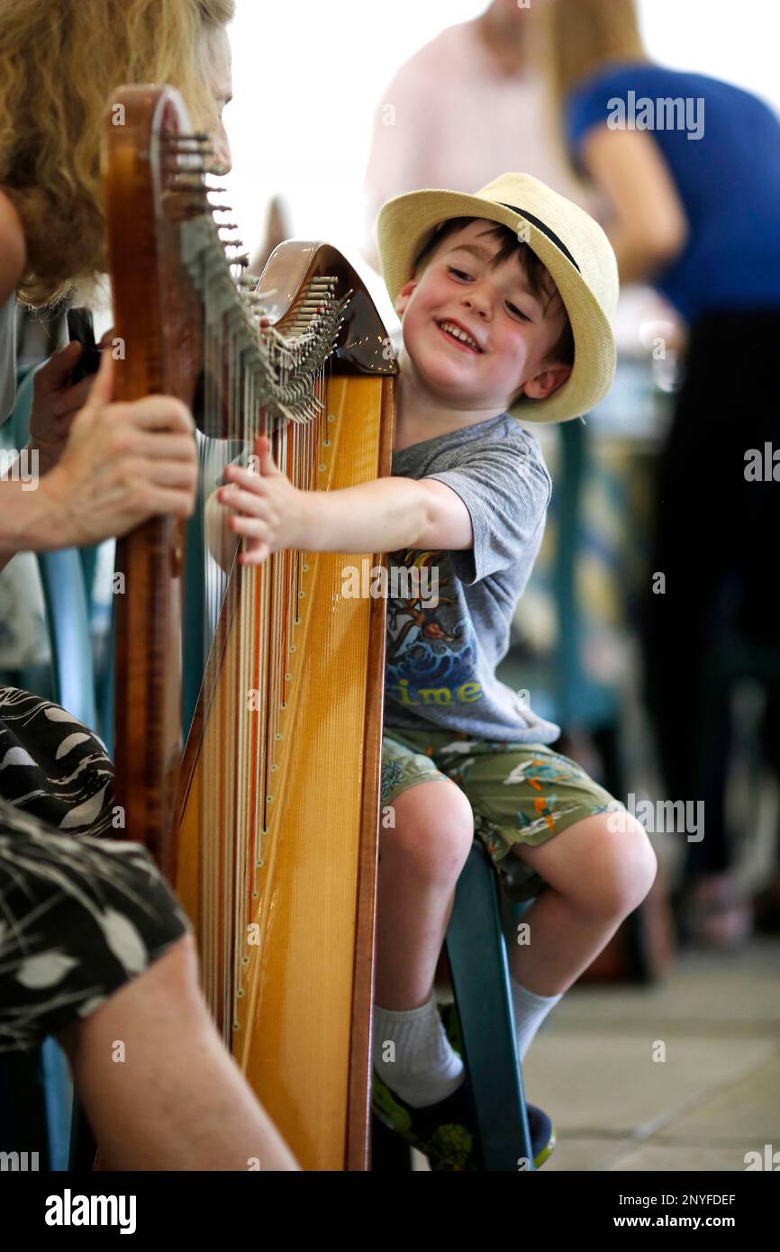 Rodric Rustay, 5, learns to play the harp at the instrument playground ...