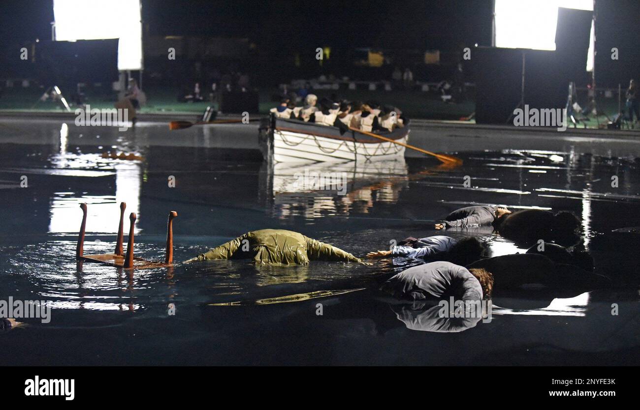 Mannequins and furniture float behind a lifeboat on the set of ...