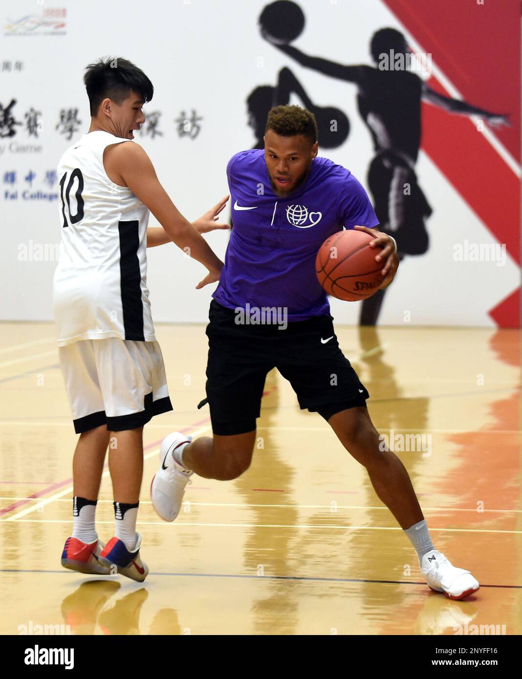 American basketball player Justin Anderson, right, visits Lam Tai Fai ...