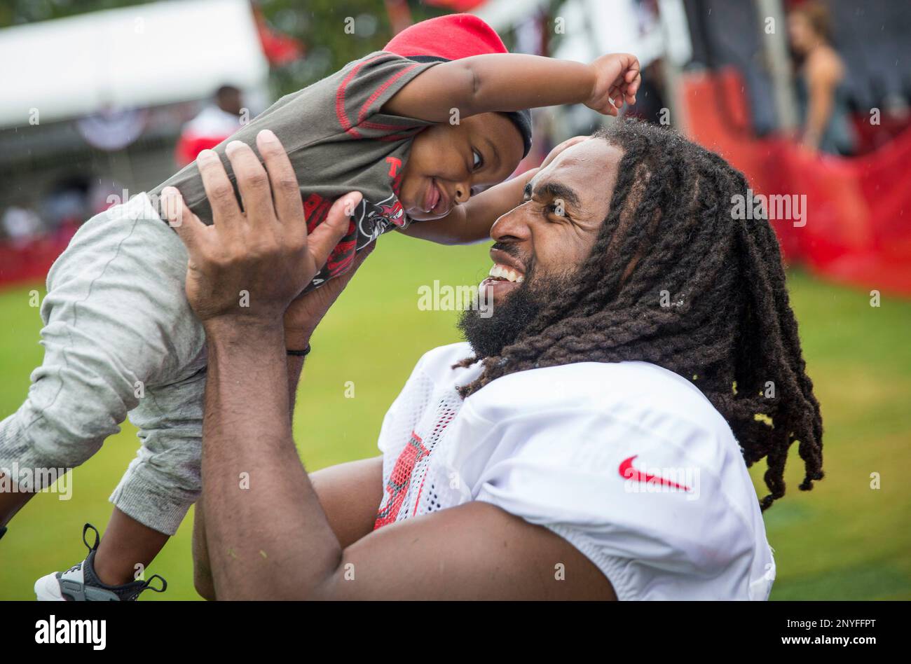 Tampa Bay Buccaneers defensive back J.J. Wilcox (27) holds son James ...