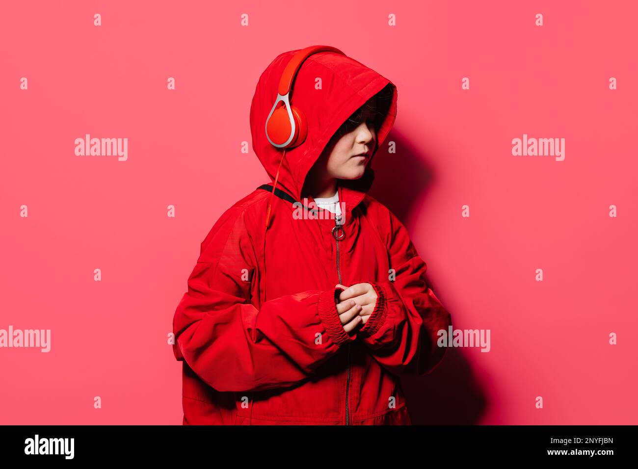 Confident unemotional young girl in headset wearing casual oversize ...