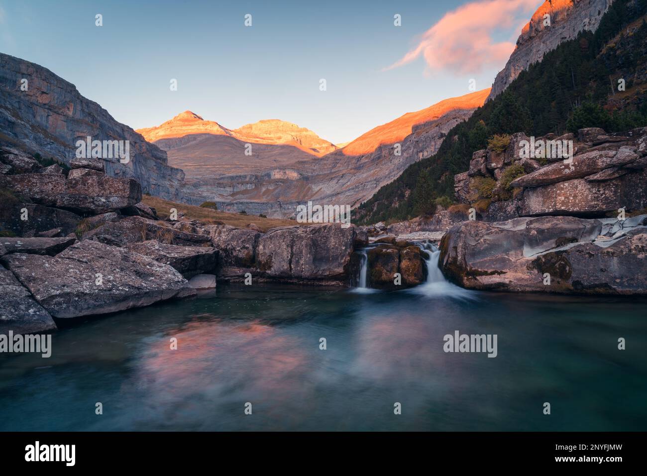 Amazing view of rapid waterfall flowing through rocky cliffs in autumn ...