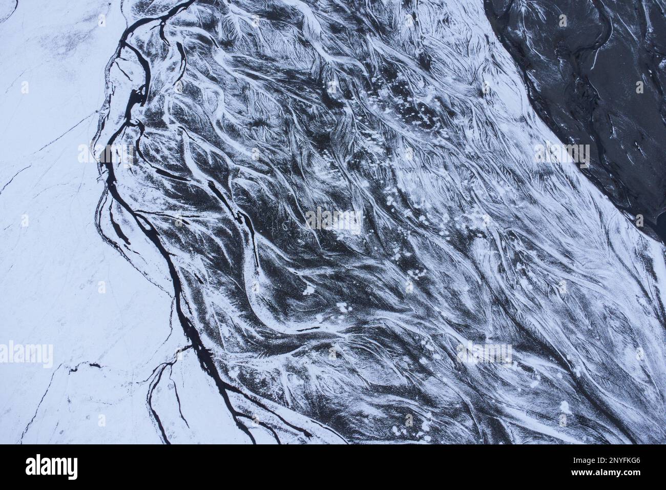 From above drone view of river estuary covered in snow in Iceland Stock ...