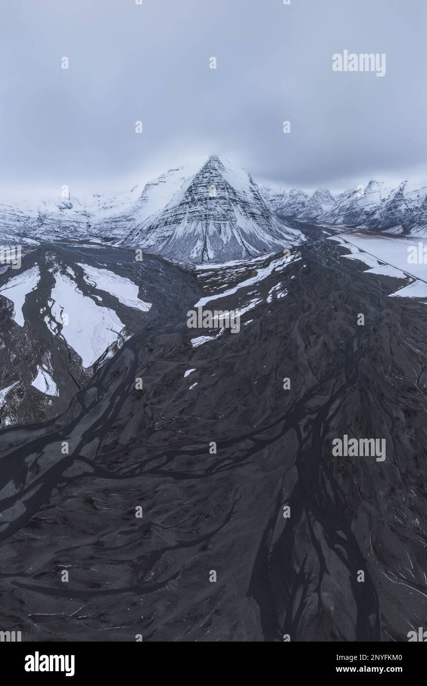 From above aerial view of river estuary covered with ice in snowy ...