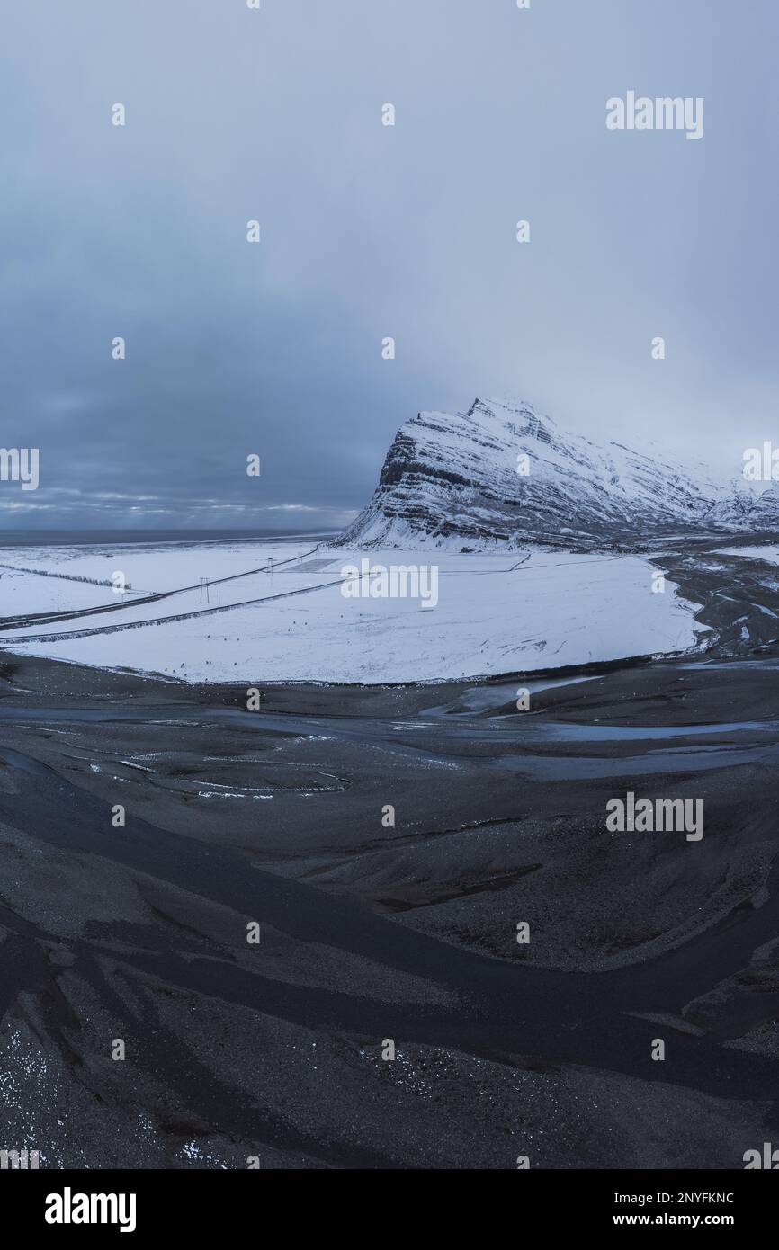 From above aerial view of river estuary covered with ice in snowy ...