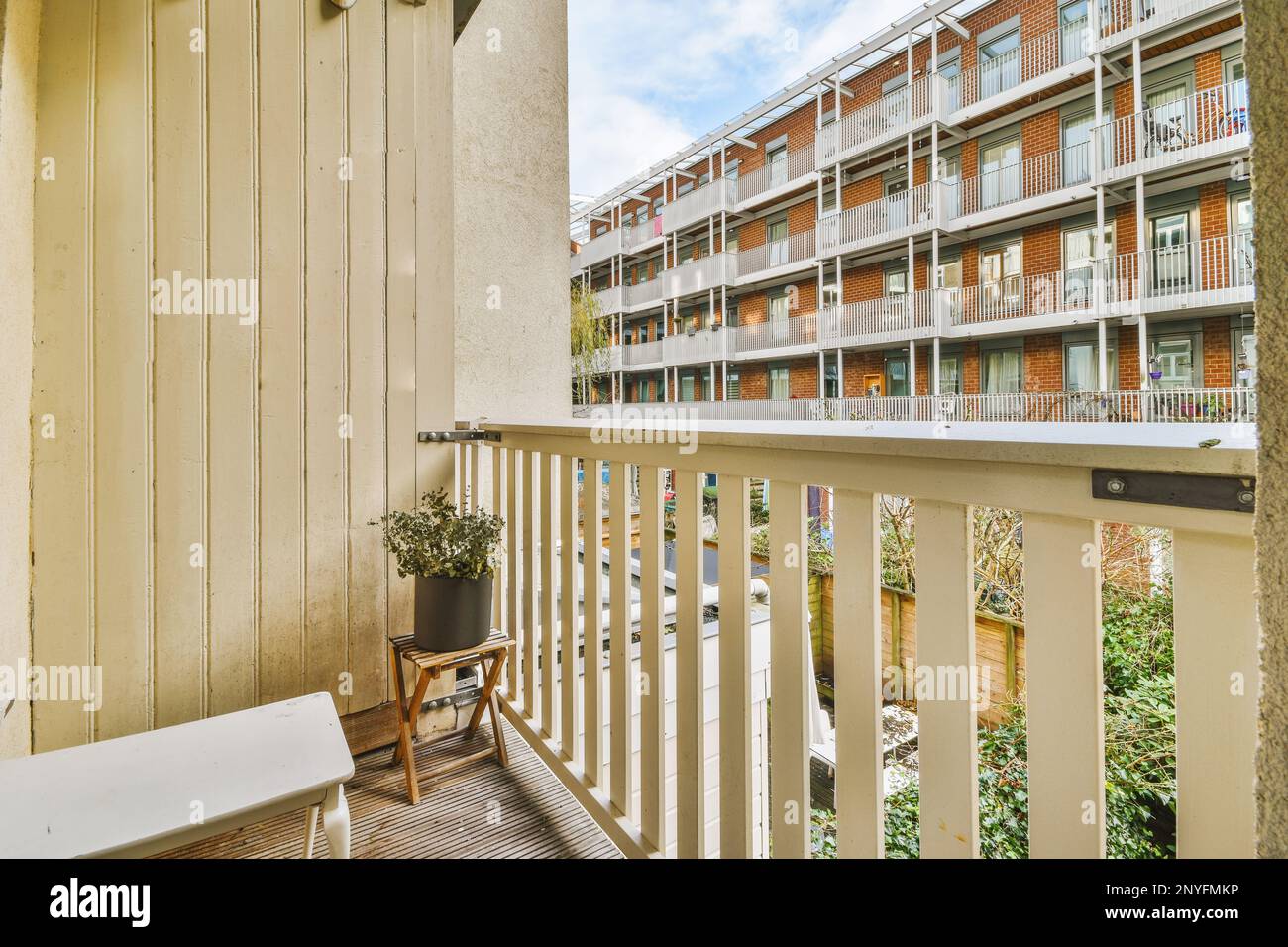 Terraced balcony of building with table and potted plants adjacent ...
