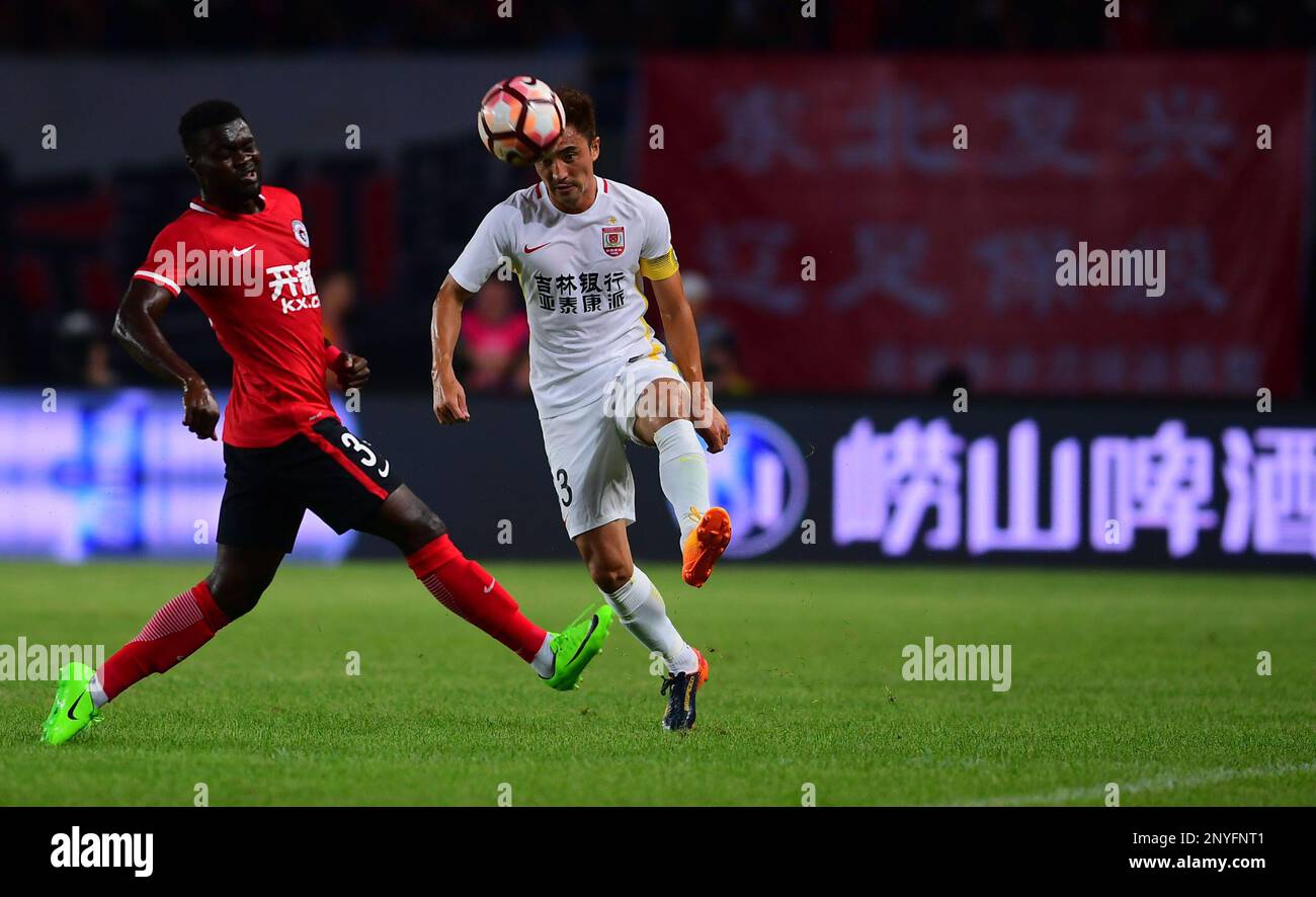 Cameroonian football player Olivier Boumal, left, of Liaoning Whowin ...