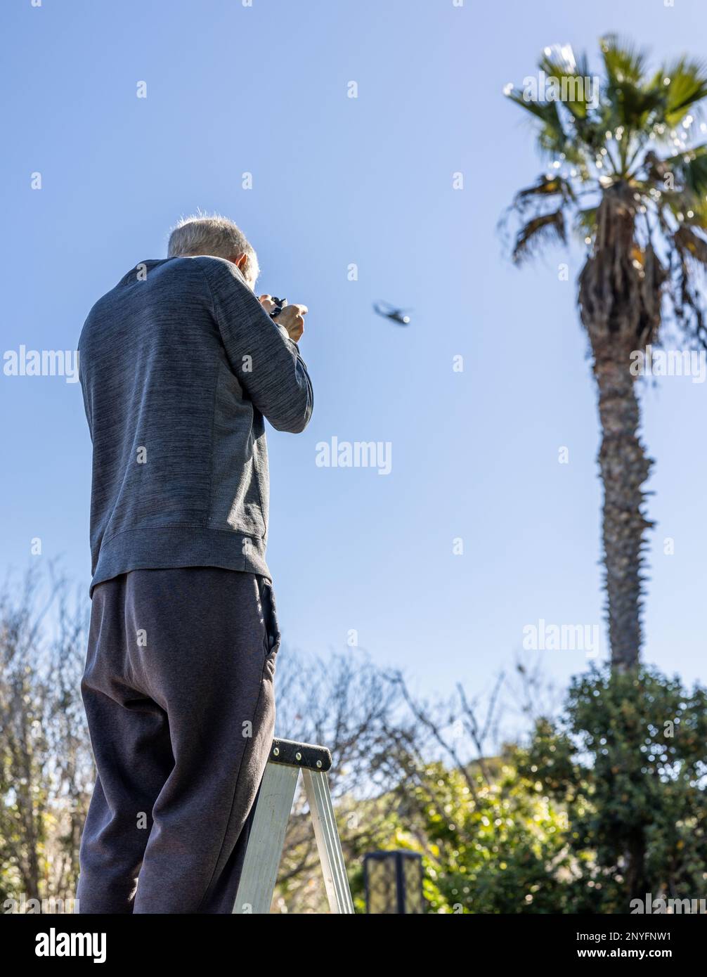 Jim Krogle, a professional artist, takes reference photos of cars with ...