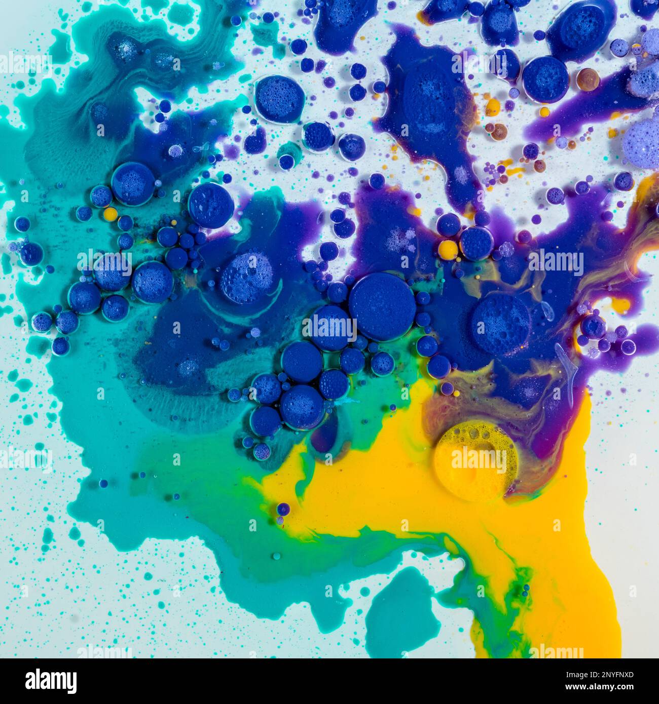 Backdrop with top view of abstract vivid blue and orange inky circles ...