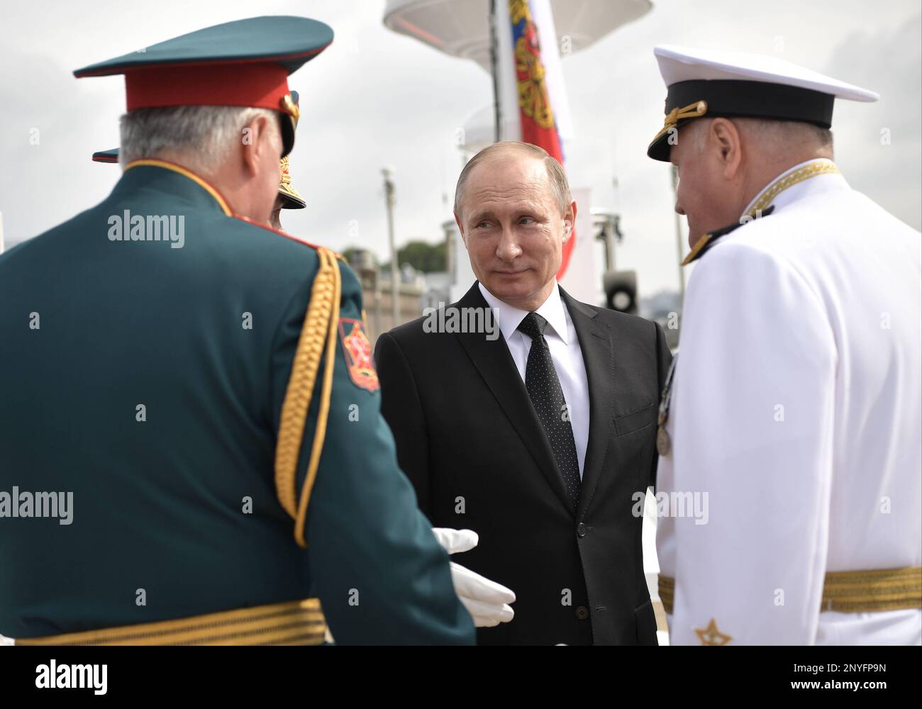 Russian President Vladimir Putin smiles riding on a boat as he attends ...