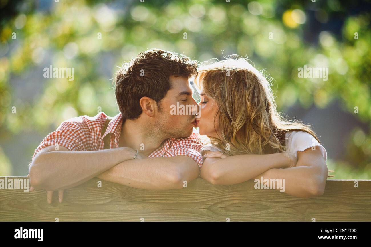Attractive couple kissing other sitting hi-res stock photography and images - Alamy