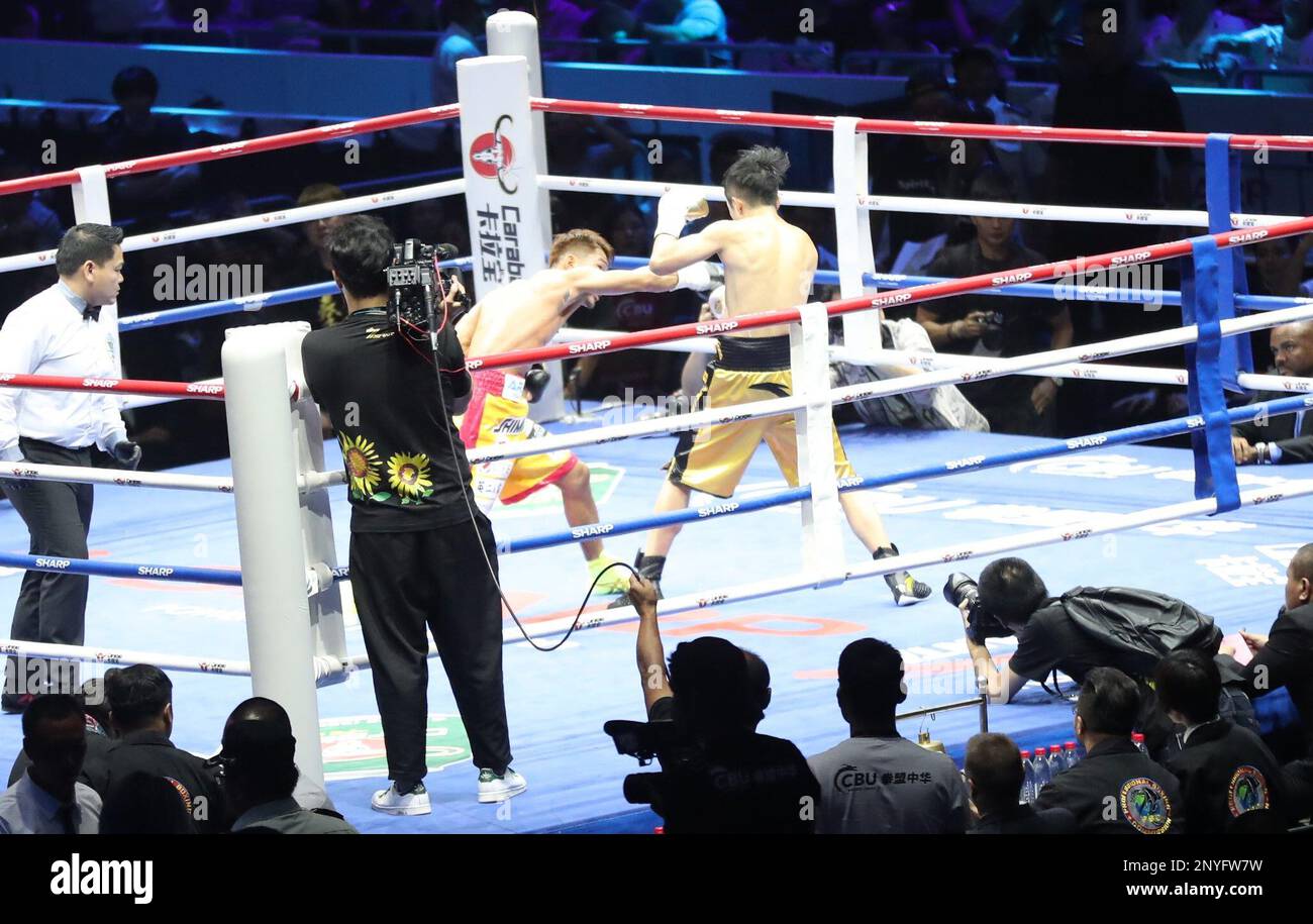 Japanese boxer Sho Kimura, center, hits Chinese boxer Zou Shiming ...