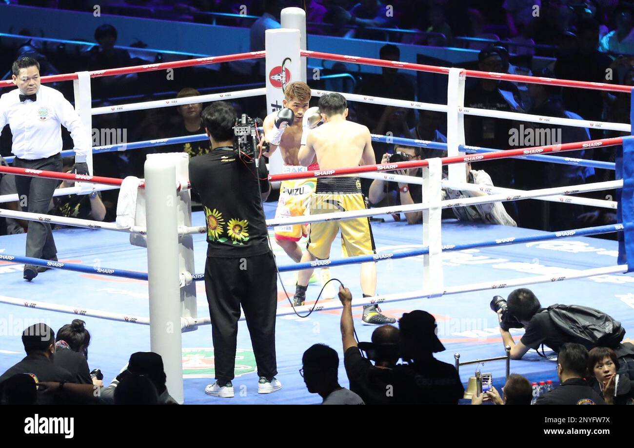 Chinese boxer Zou Shiming, right, hits Japanese boxer Sho Kimura ...