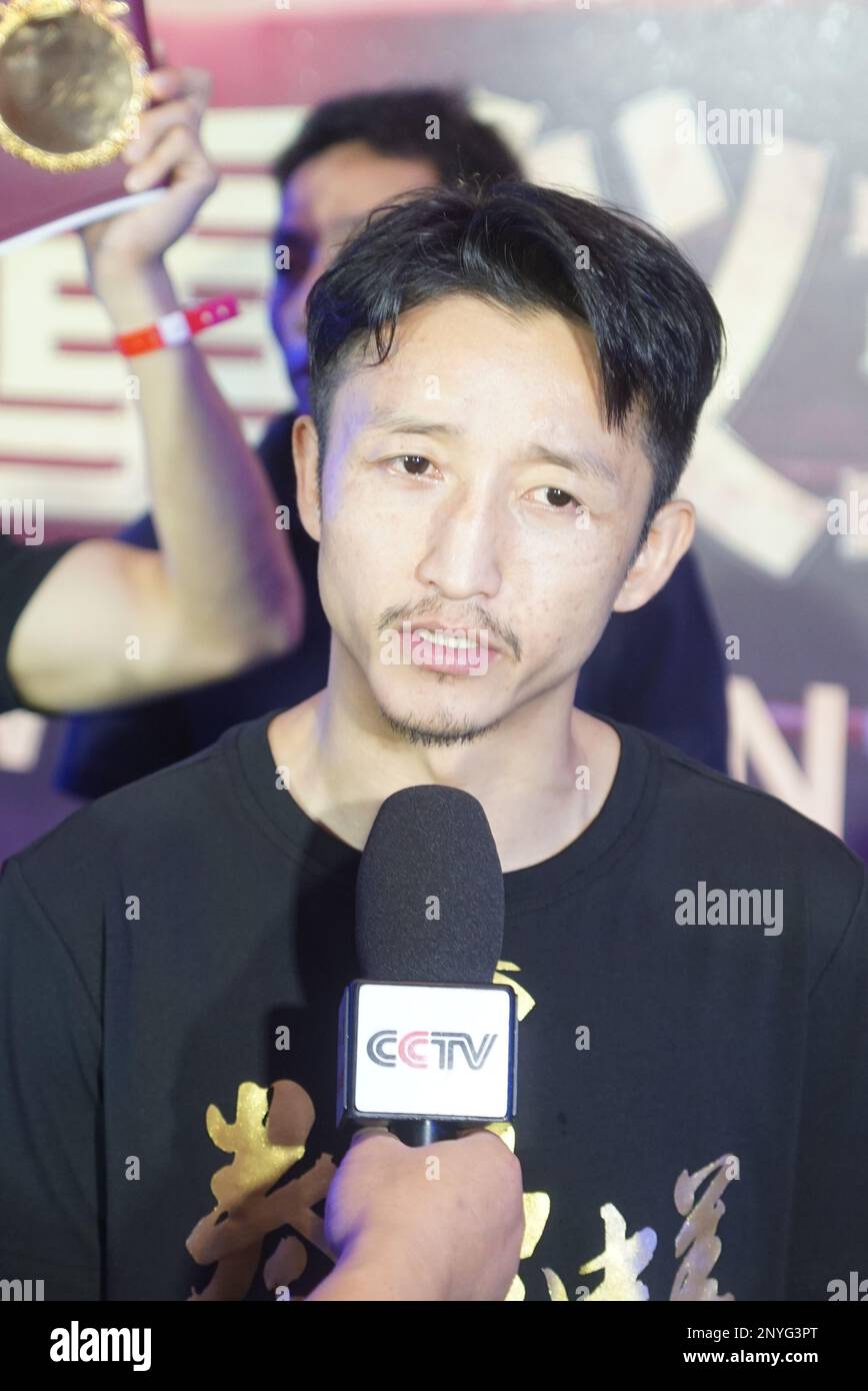Chinese boxing star Zou Shiming is interviewed at a weighing ceremony ...
