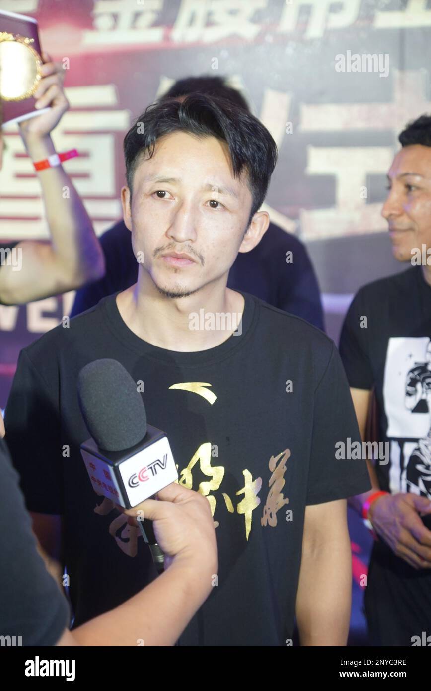 Chinese boxing star Zou Shiming is interviewed at a weighing ceremony ...