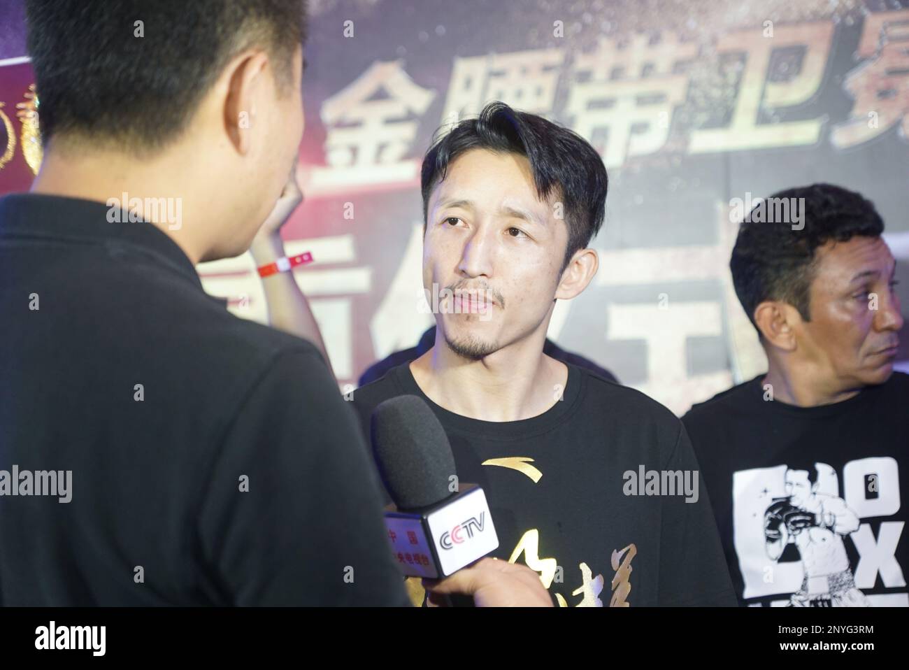 Chinese boxing star Zou Shiming is interviewed at a weighing ceremony ...