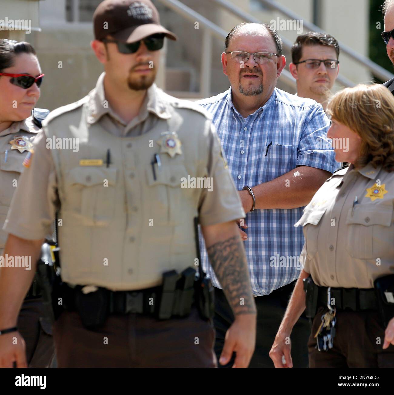 Garfield County sheriff, Jerry Niles, center, is lead from the Garfield ...