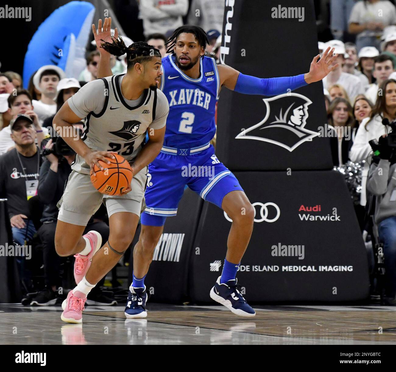 Providence forward Bryce Hopkins (23) looks to pass under the net with Xavier forward Jerome ...