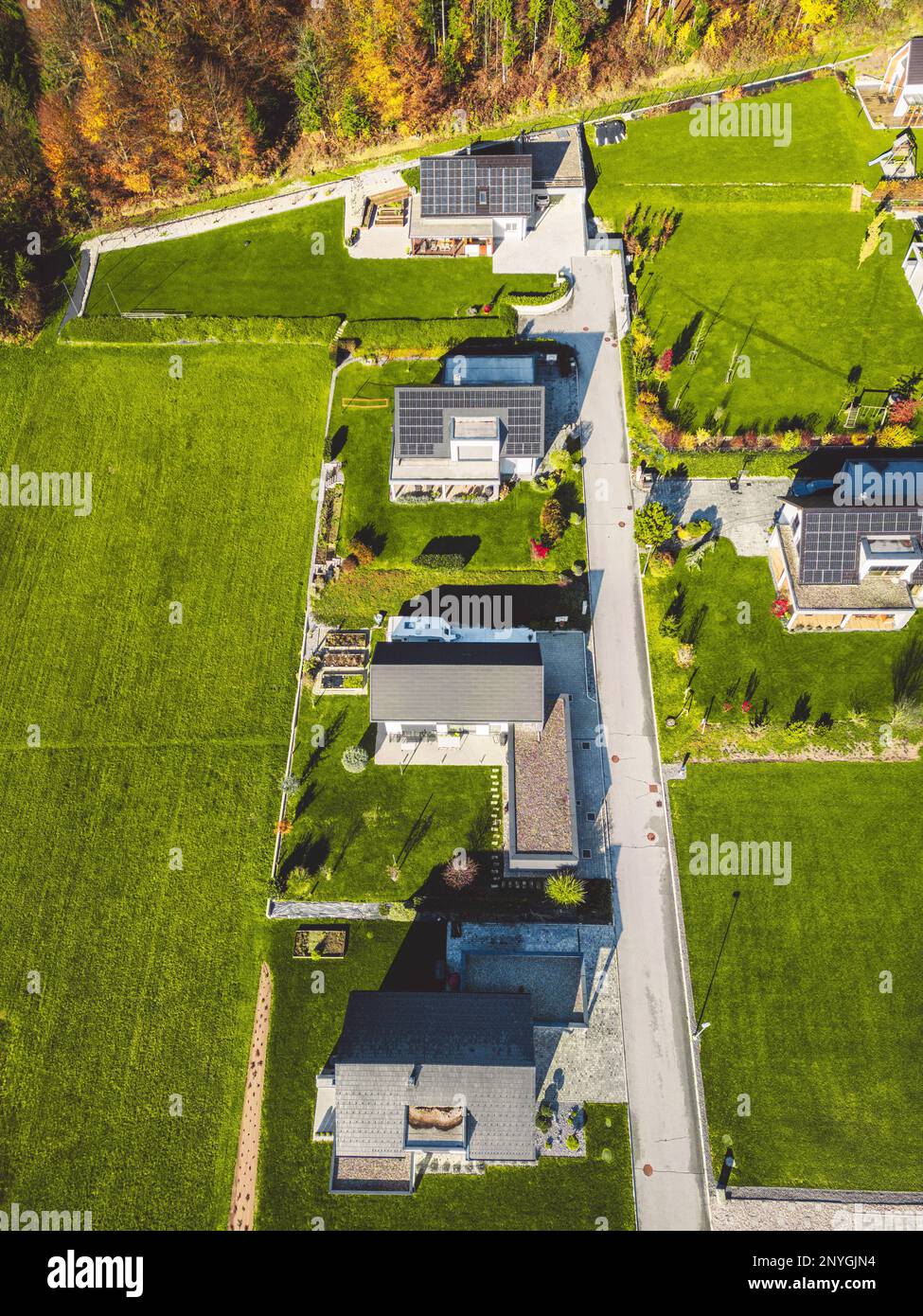 Vertical photo of four plots of land with newly build modern houses on ...