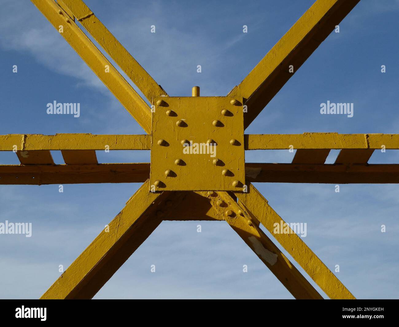 Yellow metal poles compound against blue sky background Stock Photo - Alamy