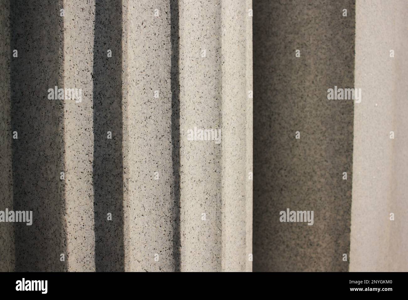 A closeup view of a fluted column carved in natural stone Stock Photo ...