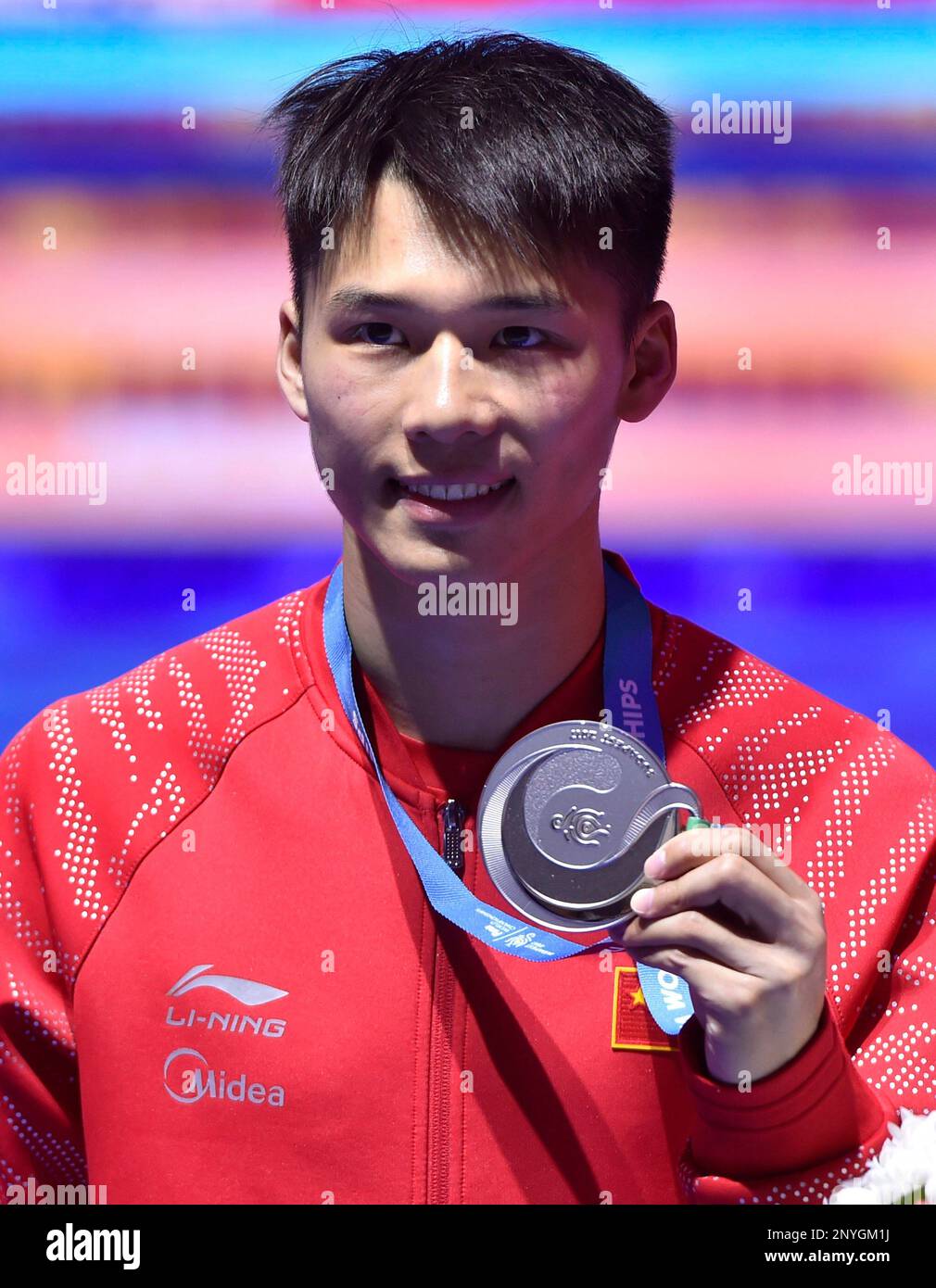 Chen Aisen of China poses with his silver medal won in the men's diving ...