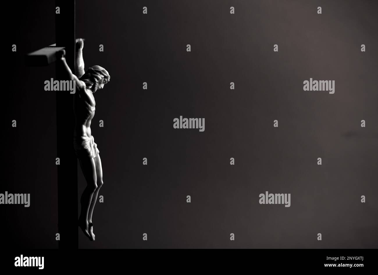 crucifix with crucified christ in black and white, space for text ...