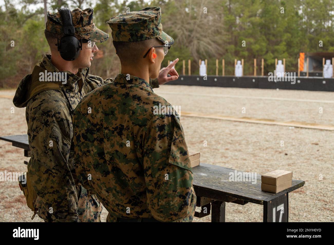 U.S. Marines with the School of Infantry-East, Combat Instructor School, coach each other while ...