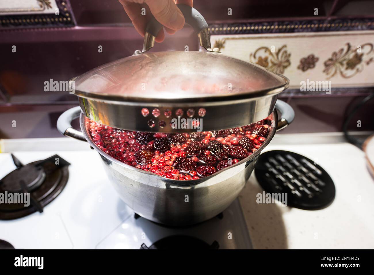 Cooking pot with delicious berries compote Stock Photo - Alamy