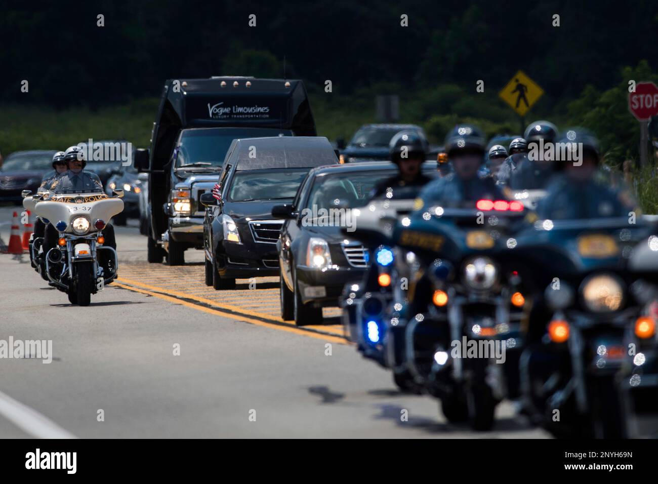 A motorcade of Pittsburgh Police motorcycles lead the way, as the ...