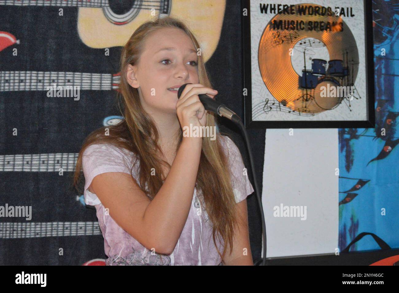 Anna Cole, 11, sings one of her songs while at her recording studio at ...