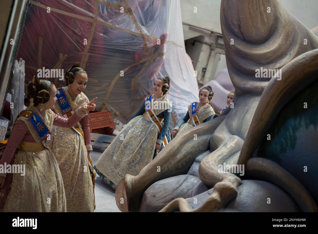 Several girls dressed as falleras during their visit to the workshops ...