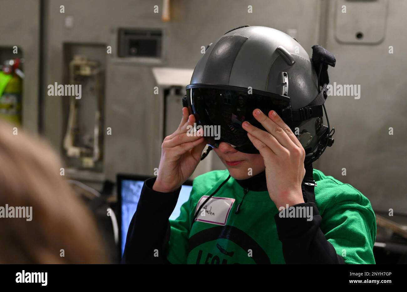 A Legacy Flight Academy student dons an aircrew helmet on a C-17 ...