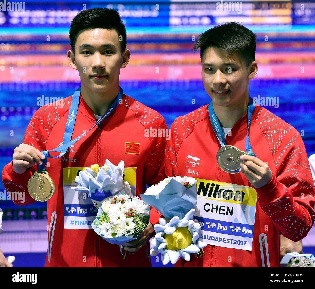 Gold medalist Yang Hao, left, and Chen Aisen of China pose with their medals during the medal ...