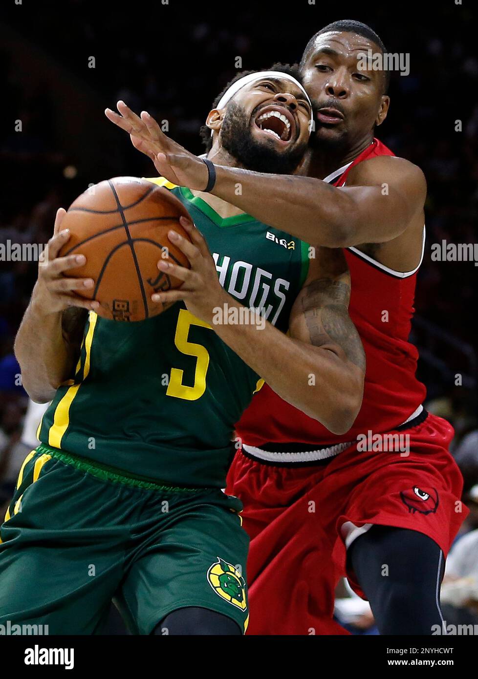 BallHogs' Xavier Silas (5) heads to the basket and is fouled by Trilogy ...