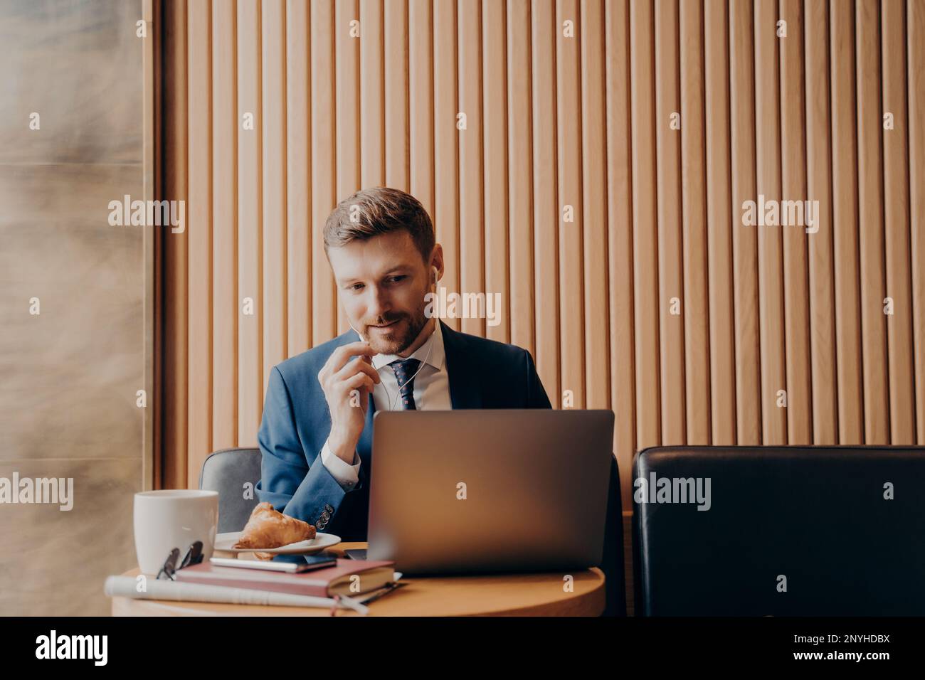 Male office manager wearing blue suit and white shirt, speaking to his ...