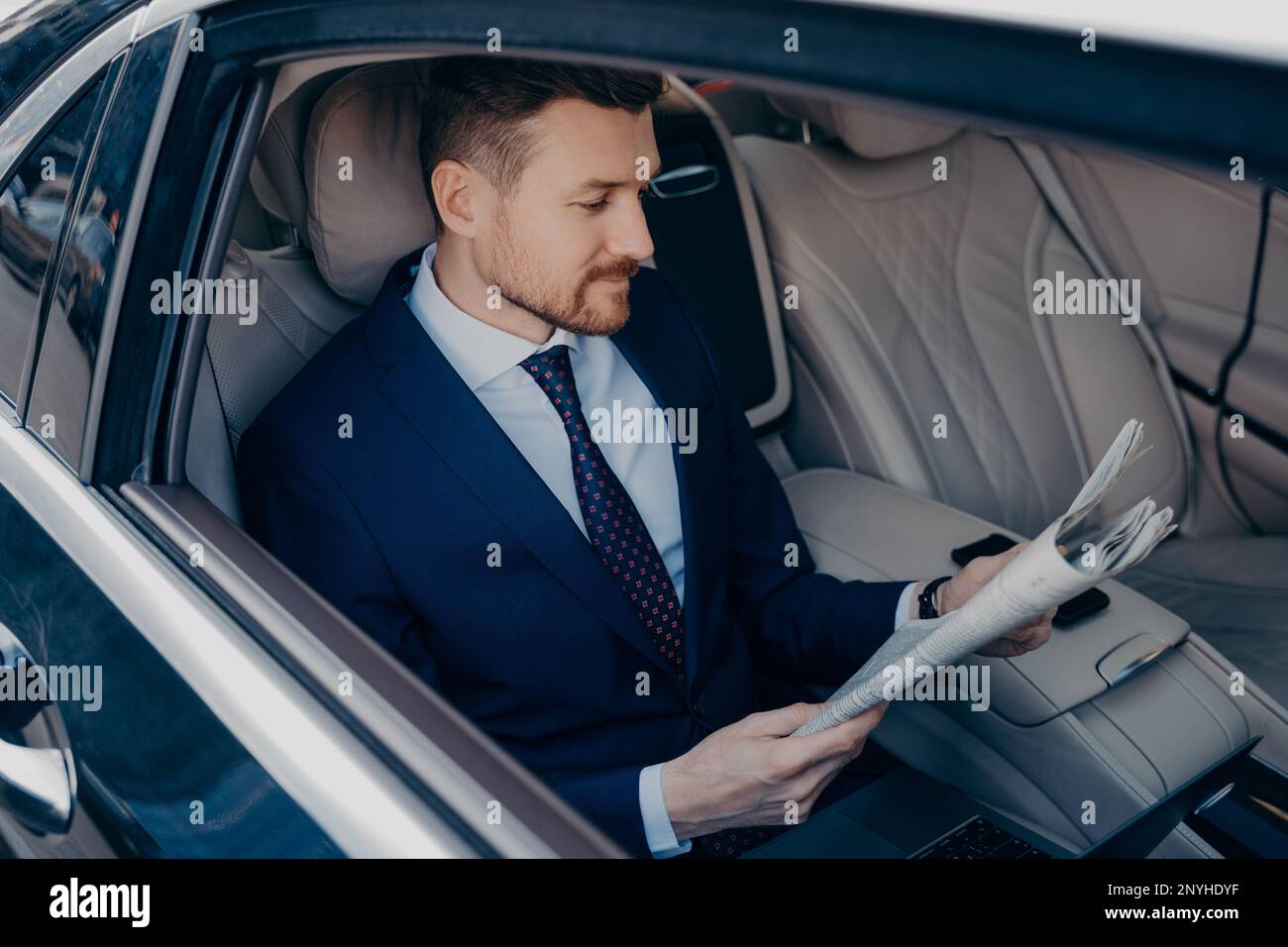 Thoughtful young bearded goodlooking executive manager in formal dark ...