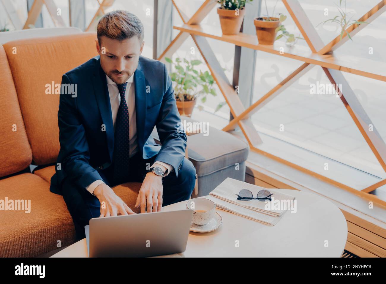 Successful well-groomed financier in stylish suit with trimmed beard ...