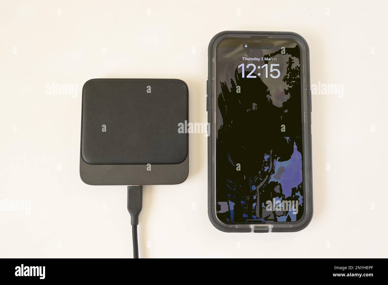 An Iphone 14 pro max and a wireless charger Stock Photo - Alamy