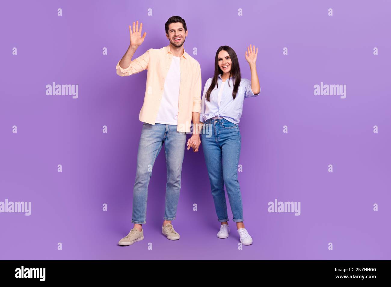 Full length photo of two positive idyllic people hold arms palms waving ...