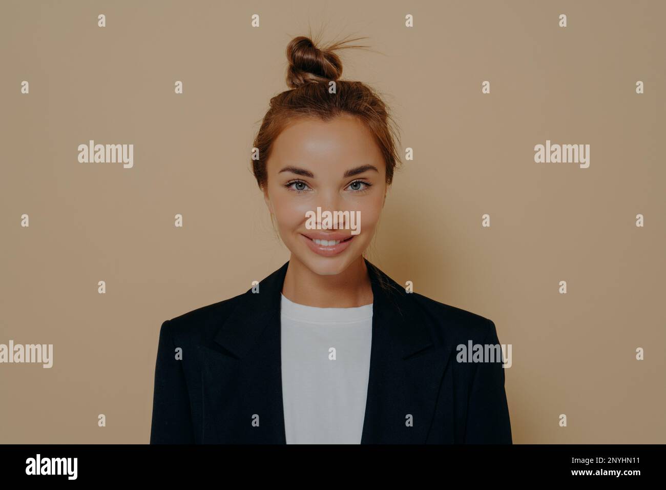 Good looking young woman with delighted face expression wearing elegant ...