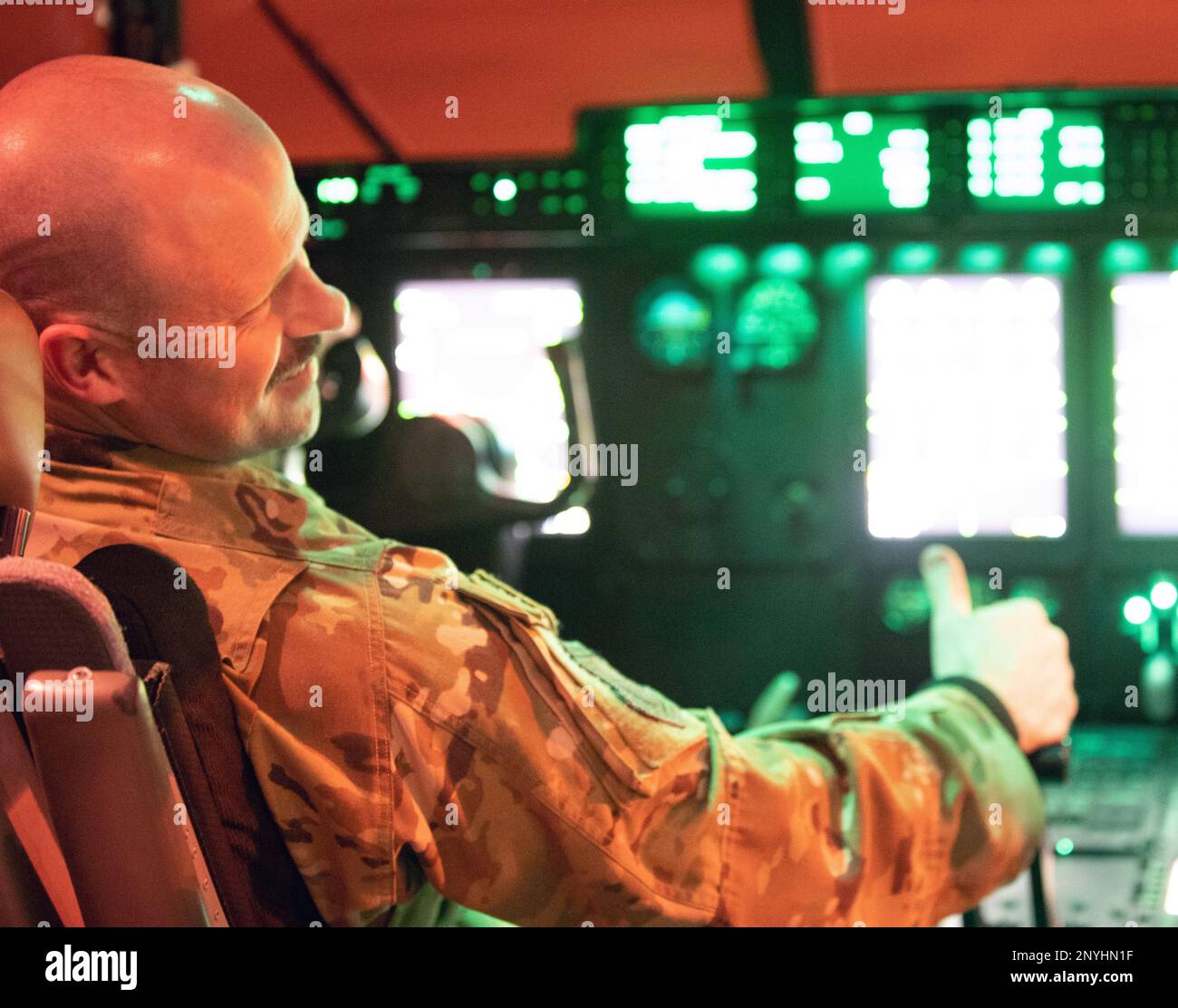 An airman poses for a photo in the cockpit of an MC-130J Commando II ...