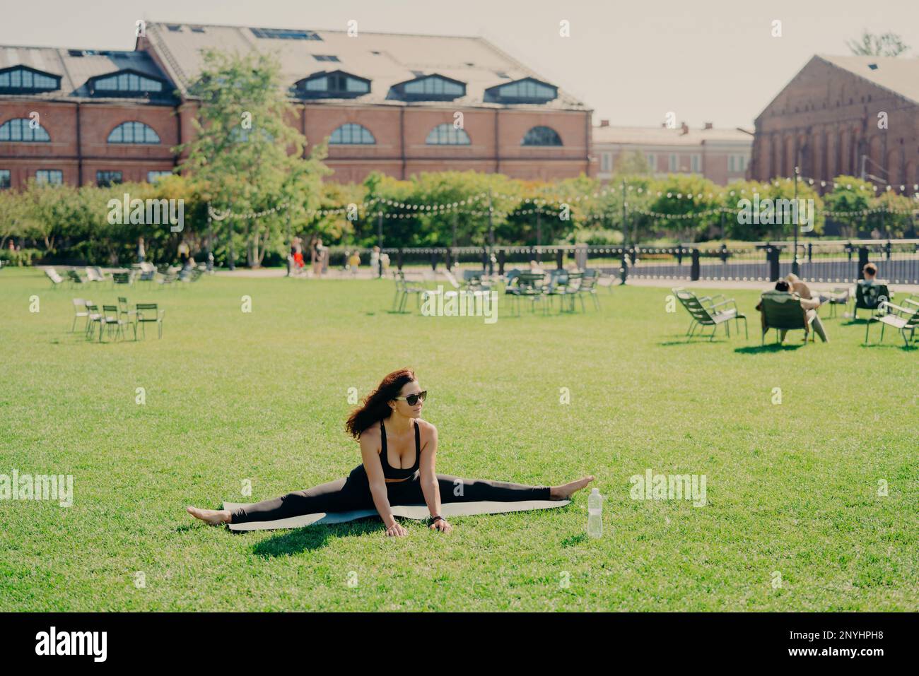 Photo of young active female model does split on karemat focused into ...